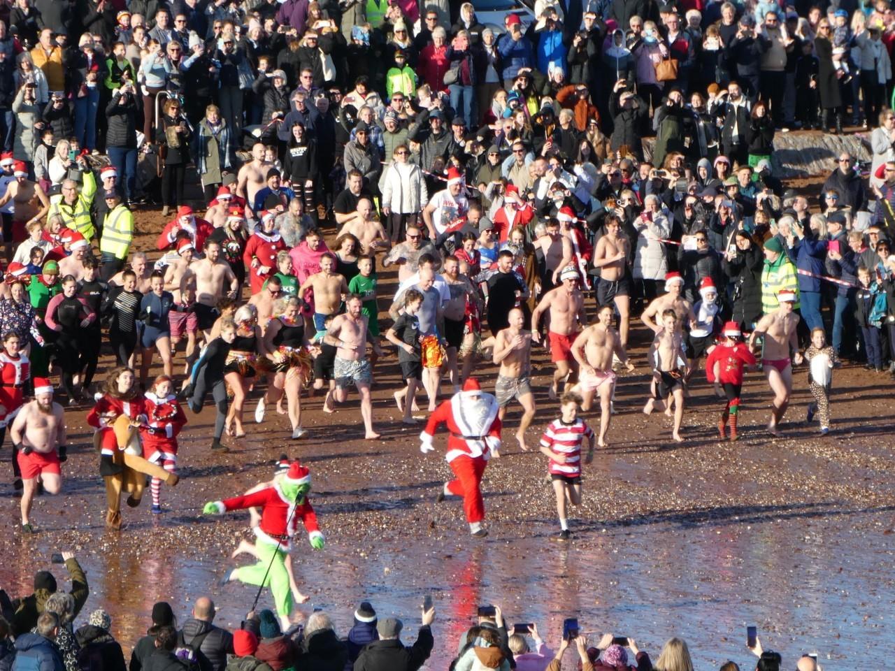 PICTURES: Paignton Lions Club's annual walk into sea raises £3,000 ...